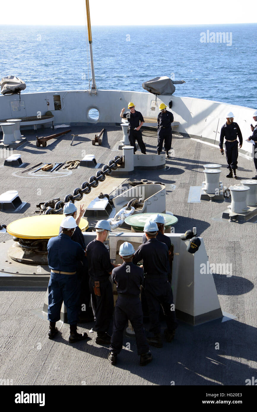 Sailors raise the anchor aboard amphibious transport dock ship USS ...