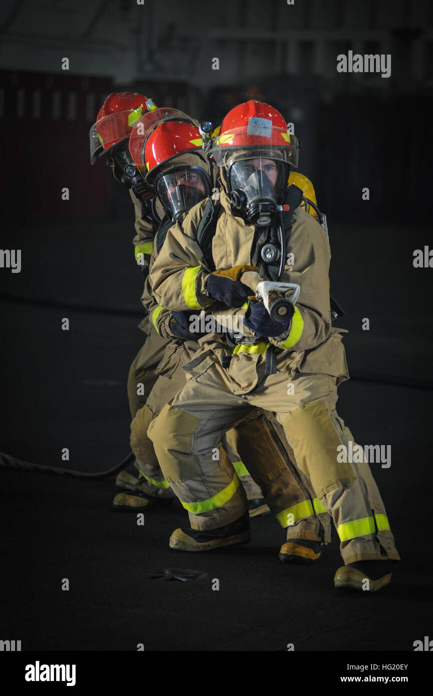 U.S. Sailors practice firefighting techniques during a drill in the ...