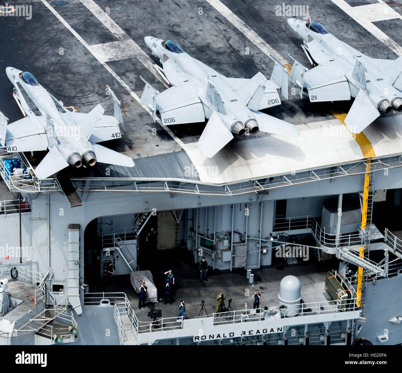 Sailors aboard the aircraft carrier USS Ronald Reagan (CVN 76) film ...
