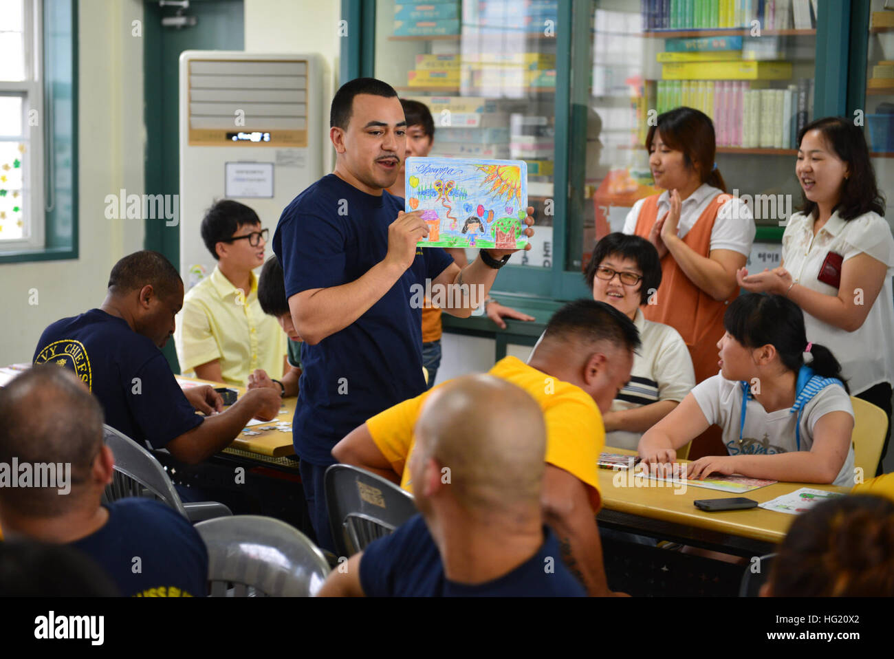 Chief Engineman David Magana shows off a drawing made by a patient at ...