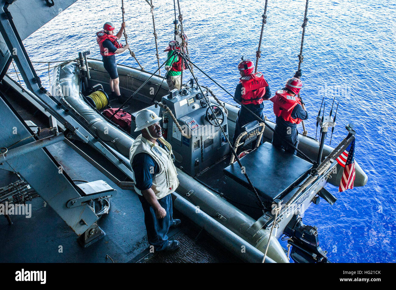 U.S. Sailors launch a rigid-hull inflatable boat aboard the aircraft ...