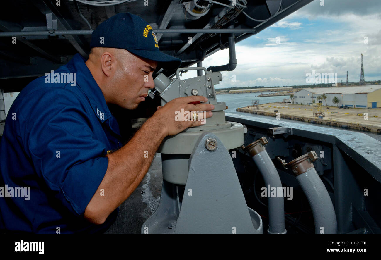Lt. Thomas Dempsey uses an alidade aboard the submarine tender USS ...