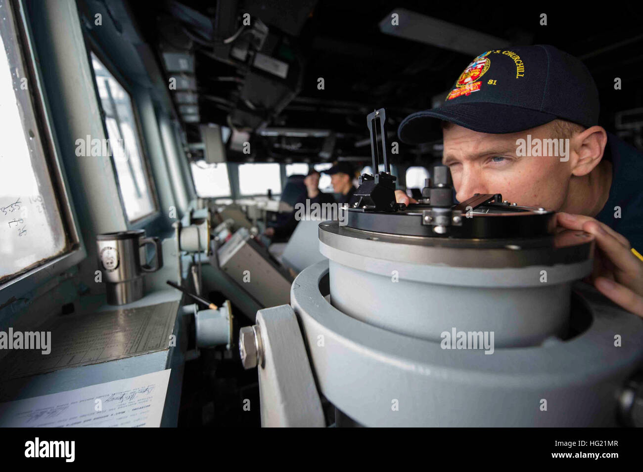 Ensign Ryan Montgomery, from Downey, Calif., determines the bearing of ...