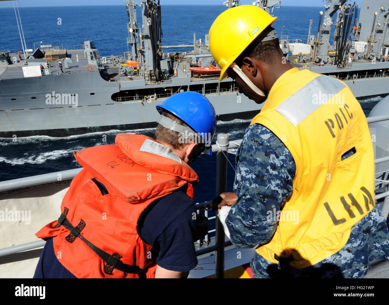 Boatswain’s Mate 1st Class Kelvin Harvey, right, connects the shot line ...