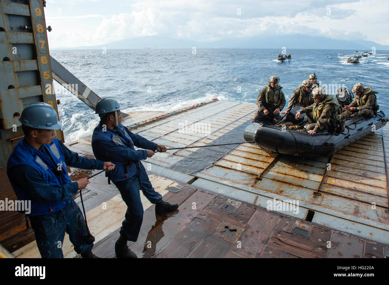 Sailors heave a Combat Rubber Raiding Crafts (CRRC) carrying Marines ...