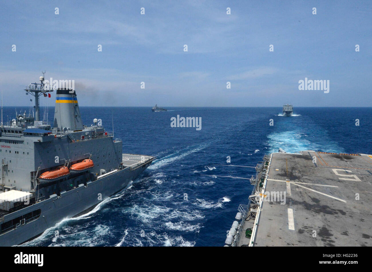 The amphibious dock landing ship USS Germantown (LSD 42) (back left ...