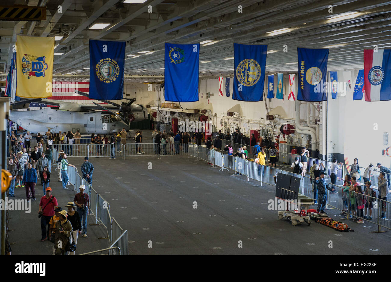 Visitors tour the hangar bay of amphibious assault ship USS America ...