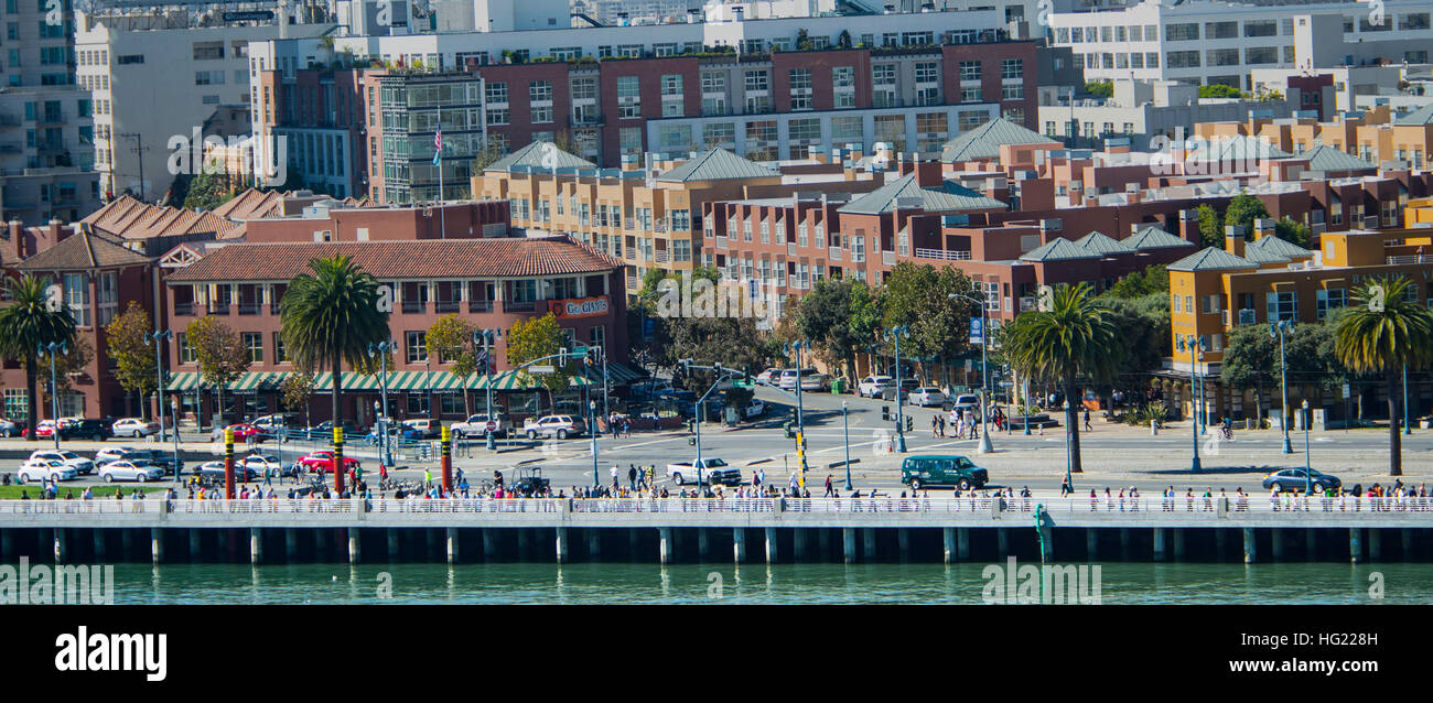 Visitors wait in line along the pier to tour amphibious assault ship ...