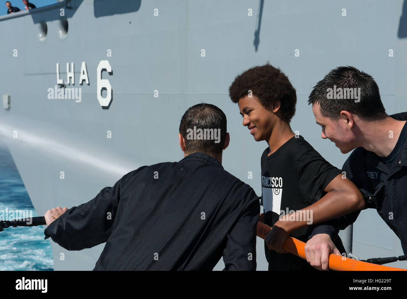 Damage Controlman Fireman Thomas Harrison, left, assigned to amphibious ...