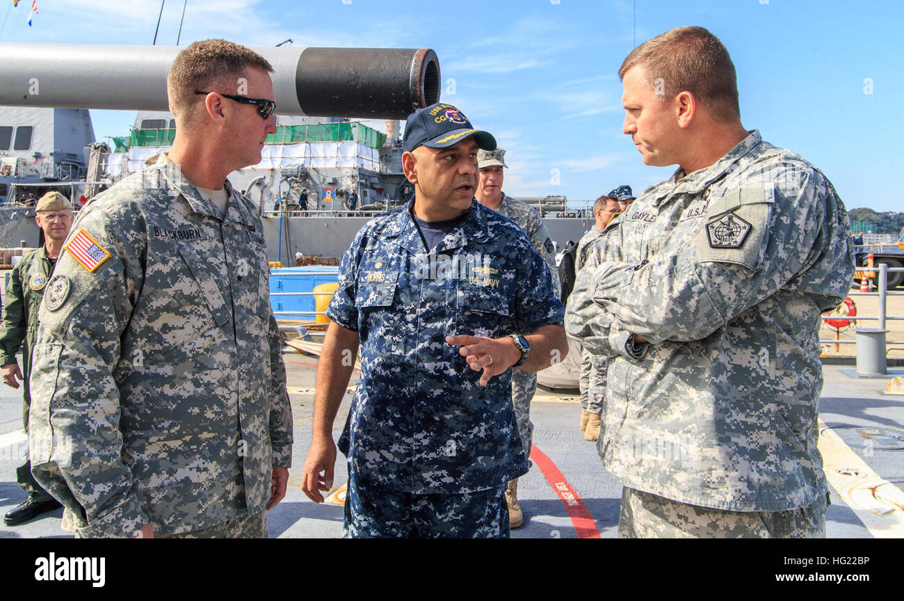 Capt. Kurush Morris, center, commanding officer of the Ticonderoga ...