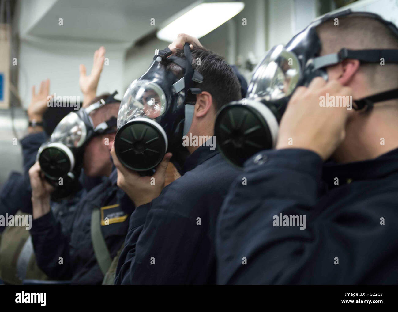 Sailors don gas masks during a chemical, biological, radiological ...
