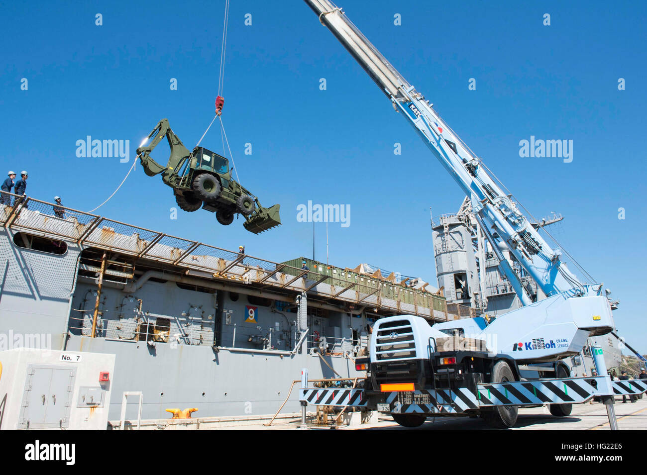A crane hoists a Backhoe, assigned to the 31st Marine Expeditionary ...