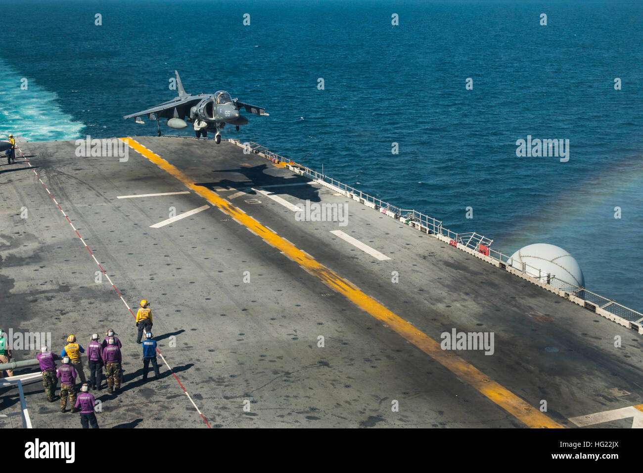 An AV-8B Harrier lands on the flight deck of Wasp-class amphibious ...