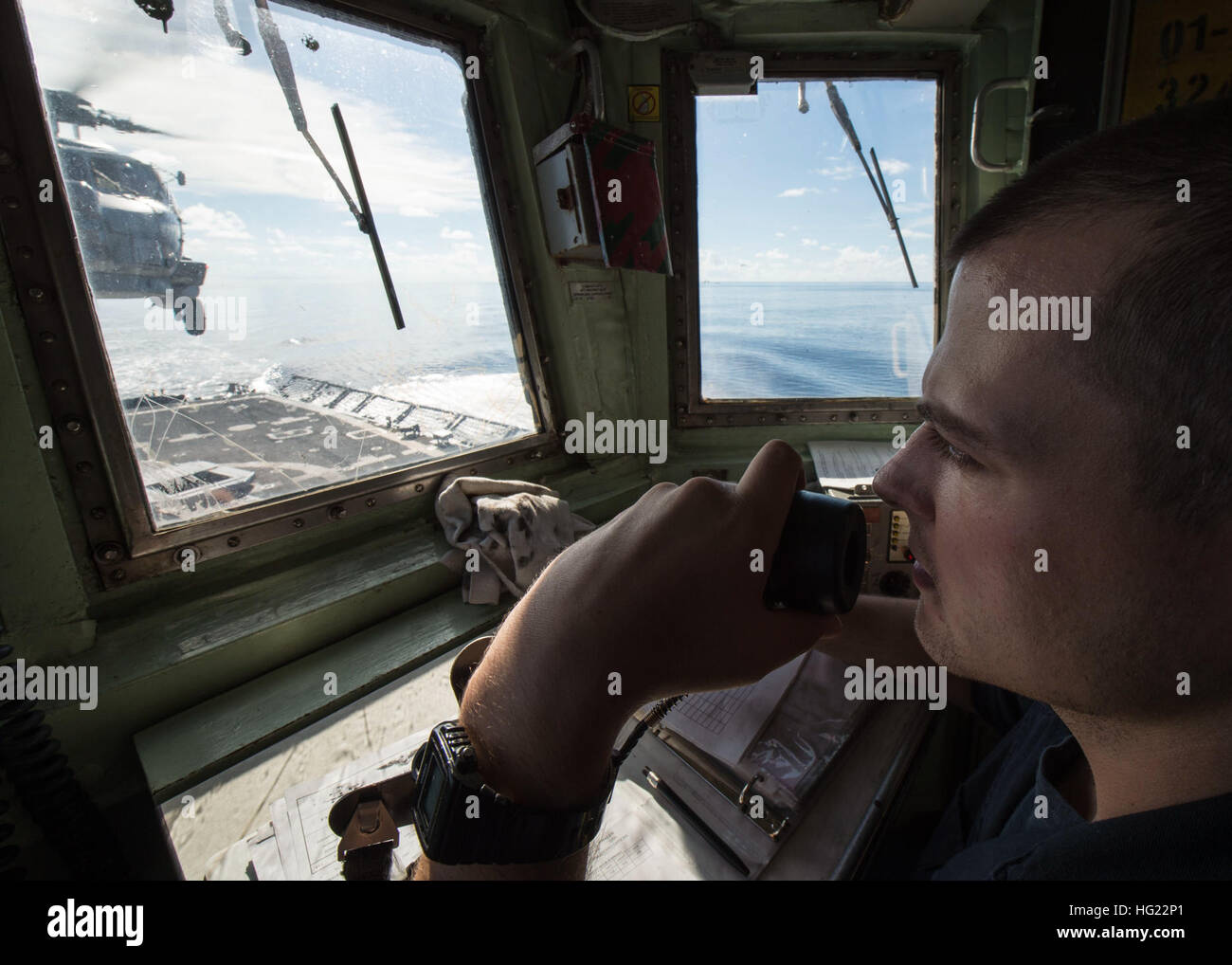 Ensign Jesse Gale, from Minneapolis, stands watch as the helicopter ...