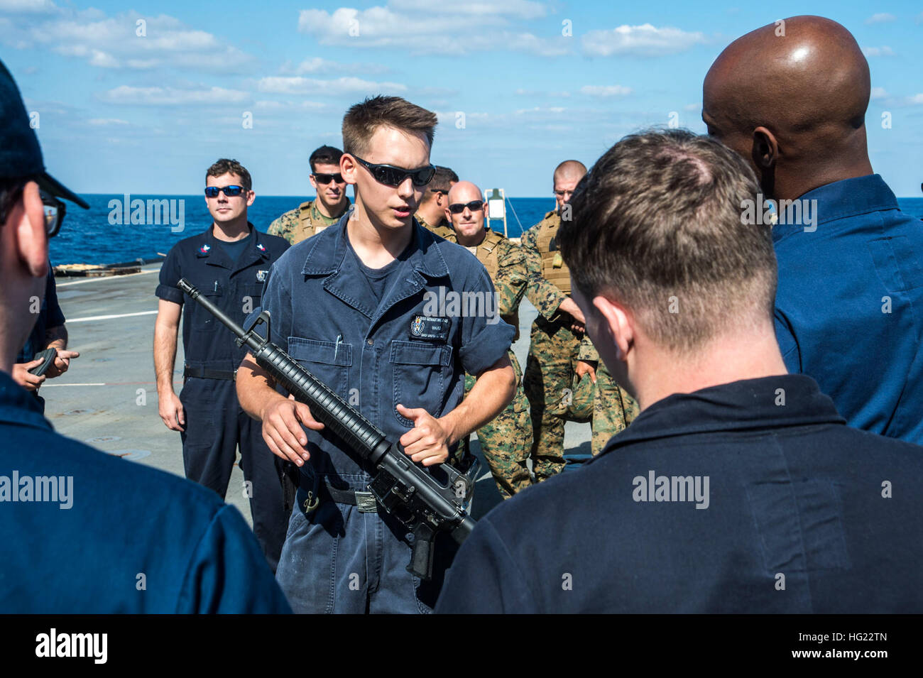 Gunner’s Mate Seaman Jonathan Ward, from Forsyth, Ga., demonstrates how ...