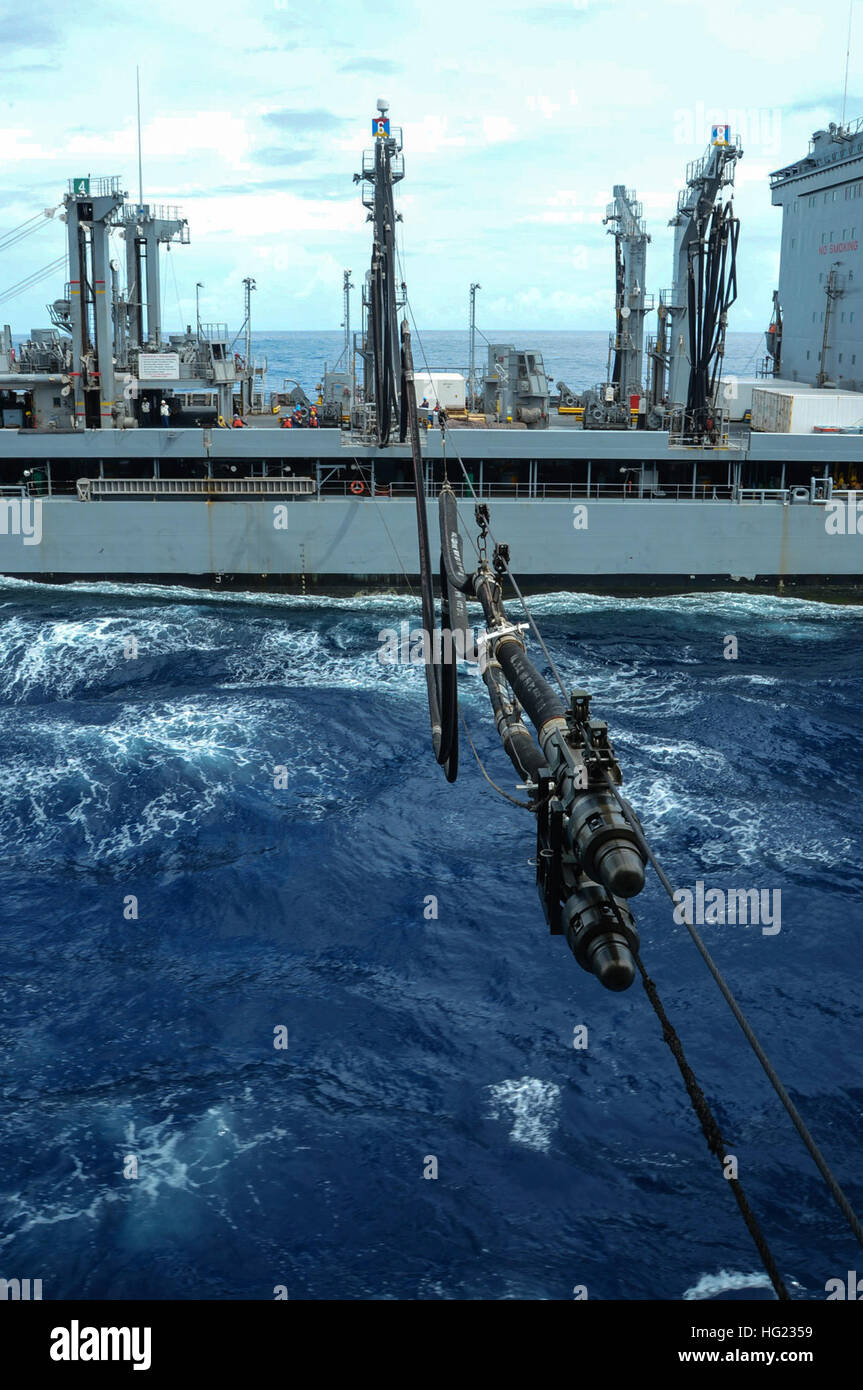 United States Naval Ship Pecos (TAO-197) passes a refueling rig to the ...