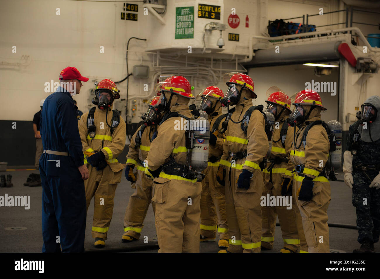 Chief Damage Controlman Wayne Jones provides feedback to a firefighting ...