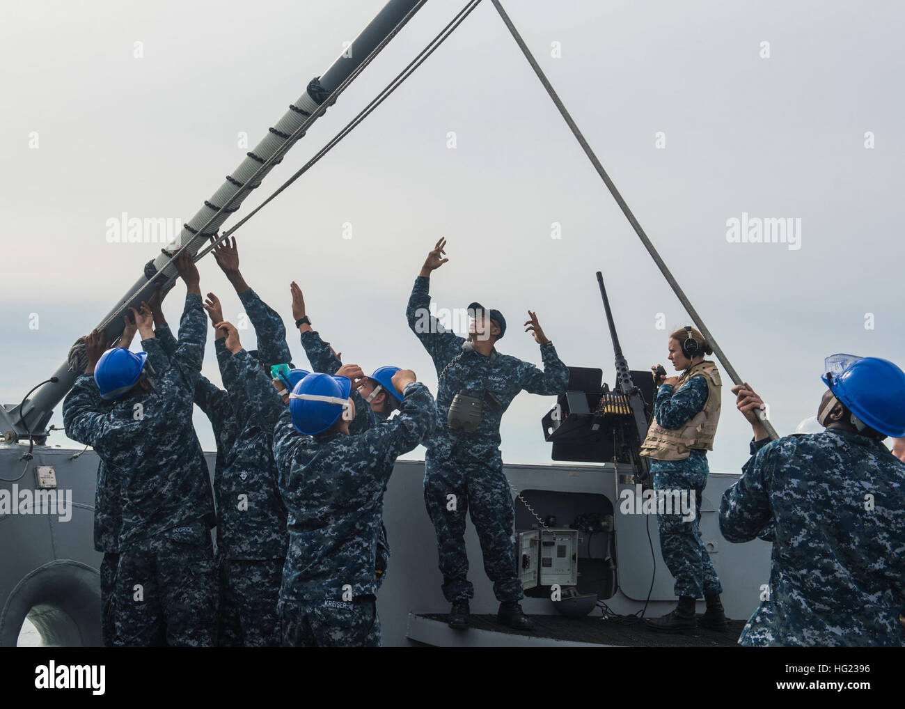 Sailors lower the jack staff aboard the San Antonio class amphibious ...