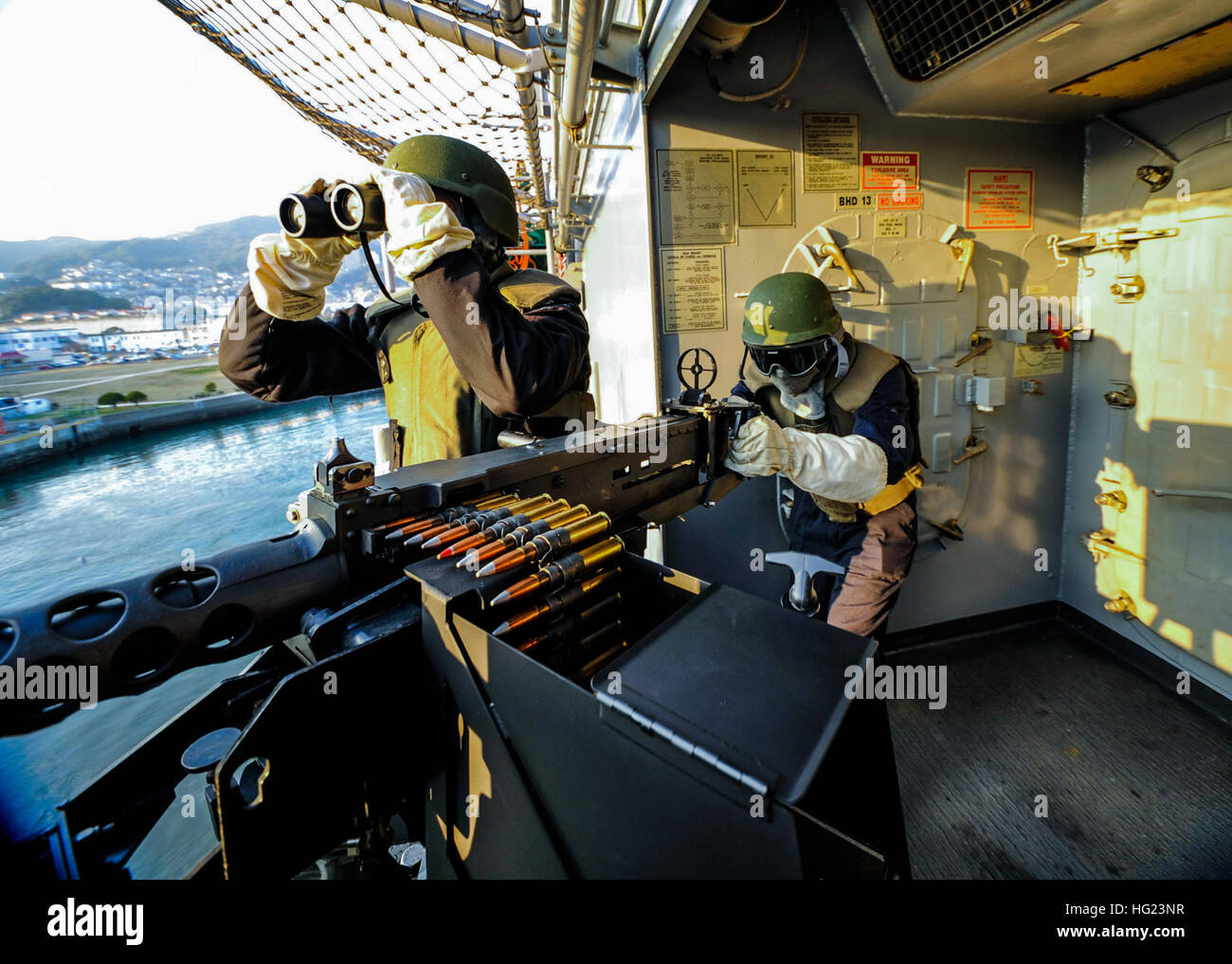 Gunner’s Mate Seaman Thomas Amason mans the .50-caliber machine gun as ...