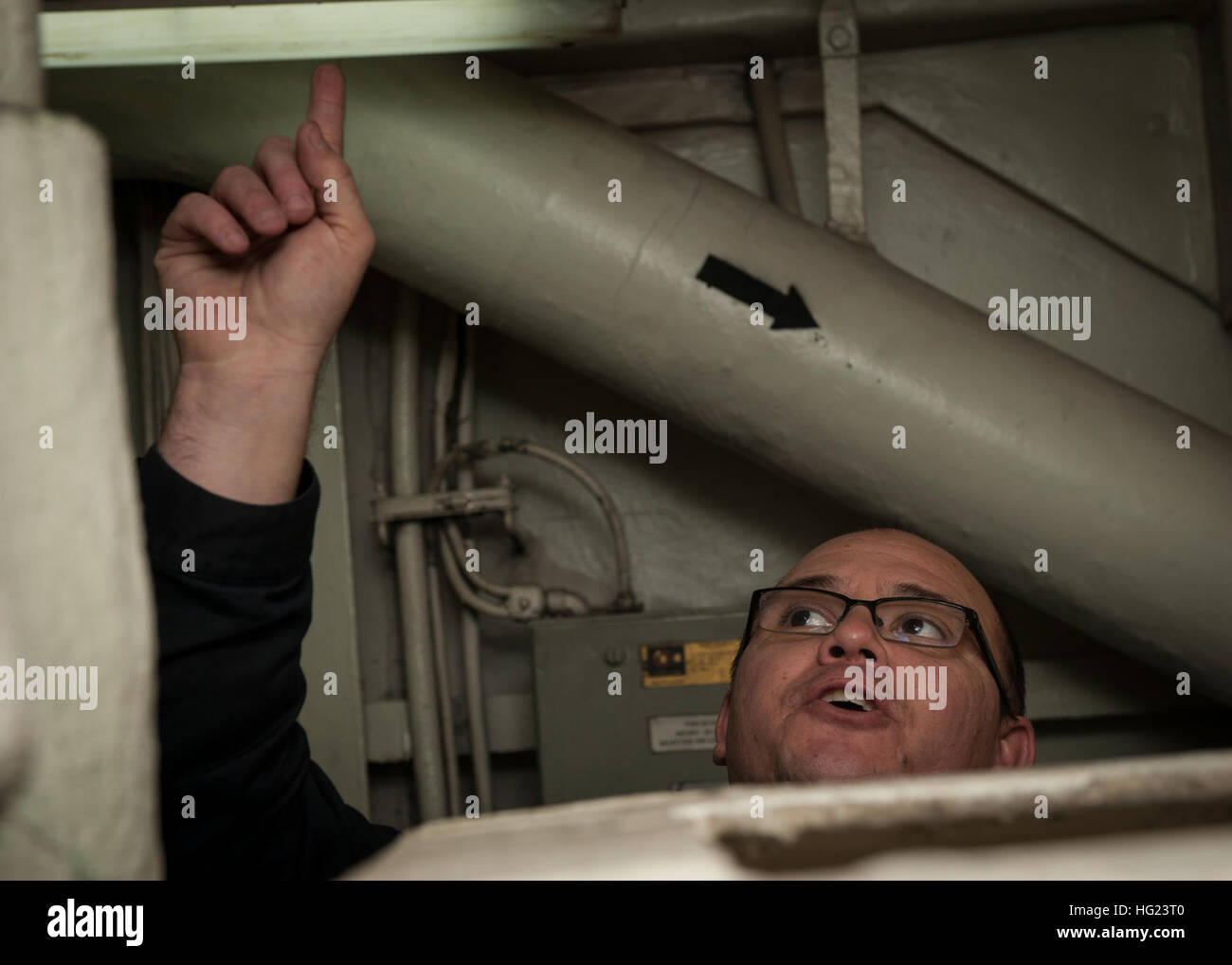 Ensign Manuel Aguilar inspects a space during zone inspection aboard ...