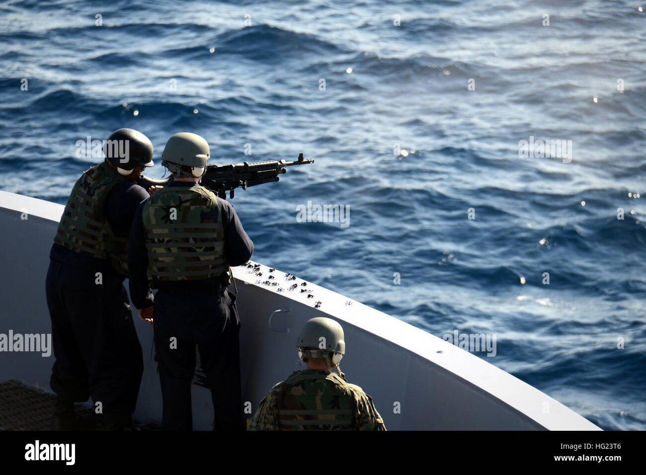 Fire Controlman 3rd Class Cliff Crum fires an M240B machine gun during ...