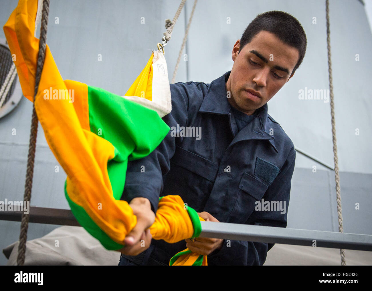 Quartermaster Seaman Anthony Rodriguez prepares flags before a underway ...