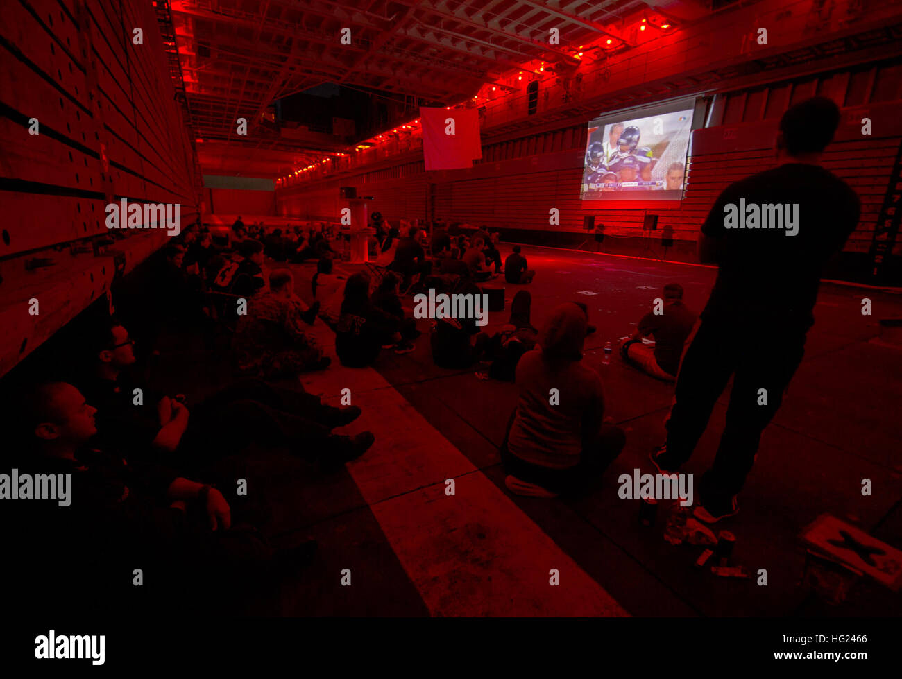 Sailors of USS Rushmore (LSD 47) watch the big game at a Super Bowl ...