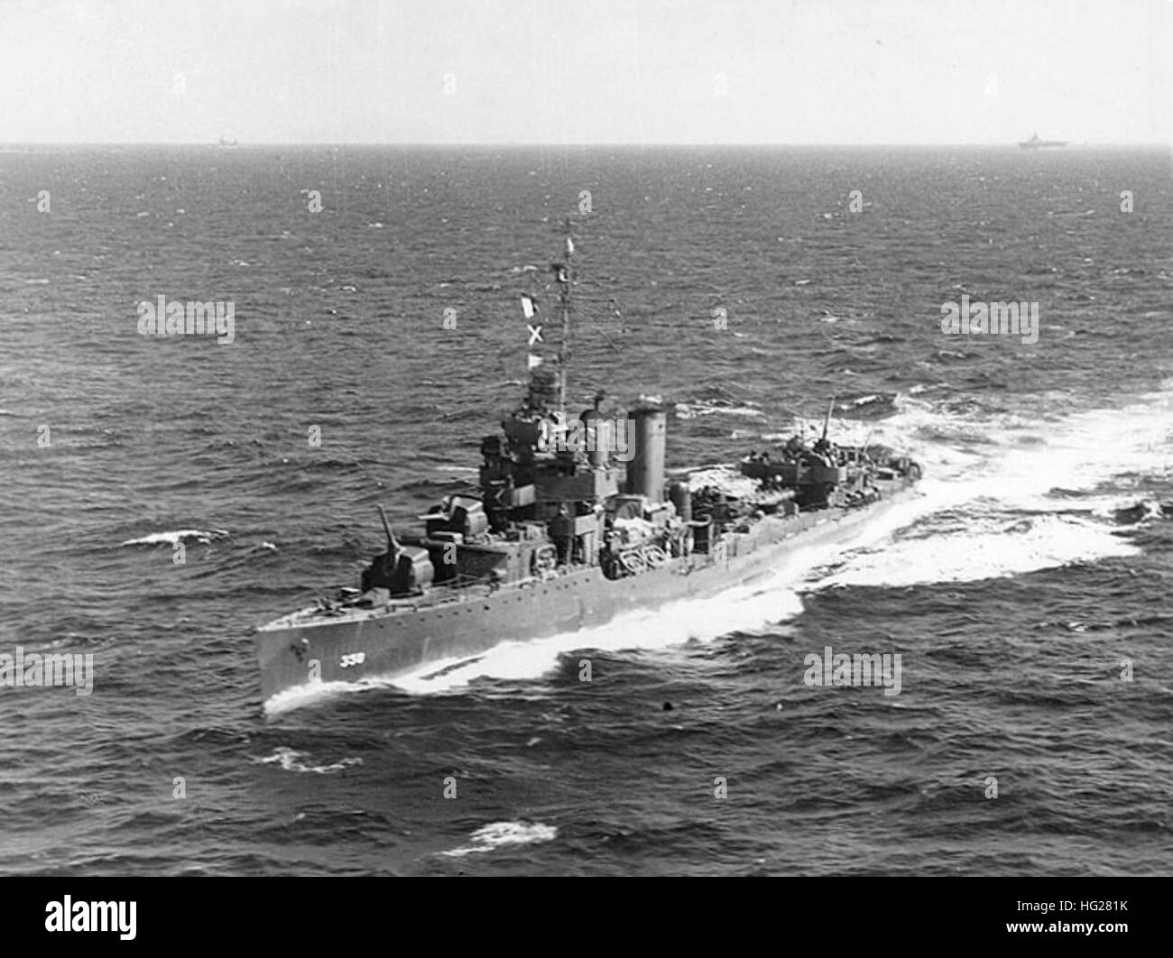 USS Hull (DD-350) at sea in May 1944, with an aircraft carrier and ...