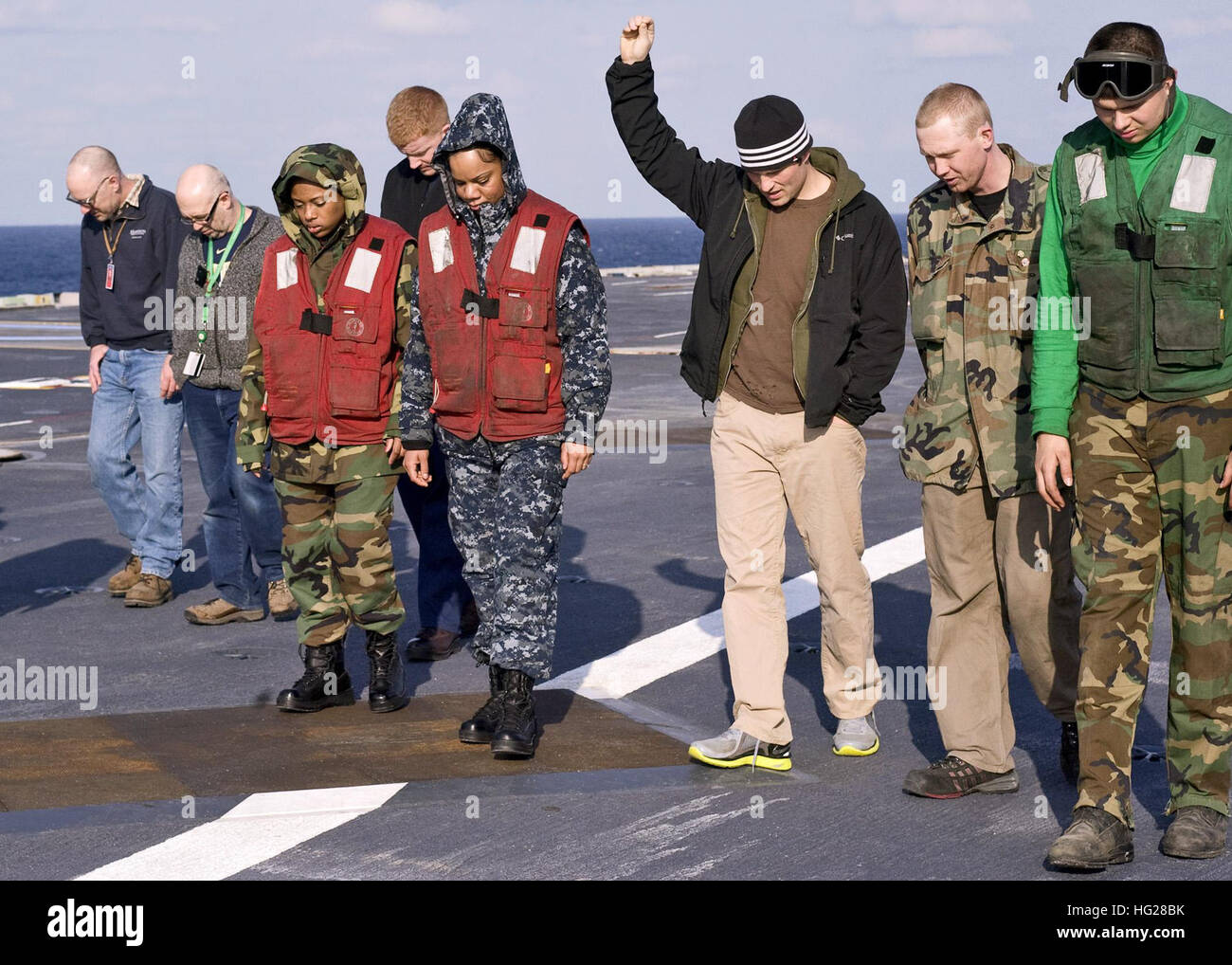 Sailors and civilian shipyard workers conduct a foreign object damage ...