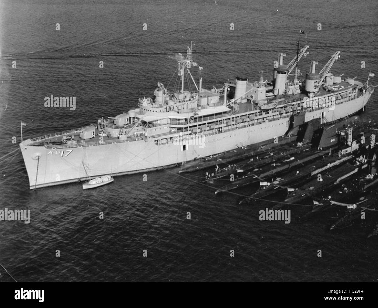 (AS-17) Moored in harbor, with several submarines alongside. The ...