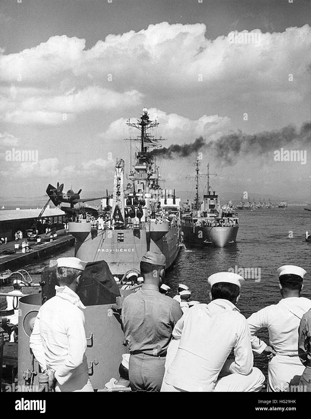 USS Providence (CL-82) with USS Chewaucan (AOG-50) coming alongside at ...