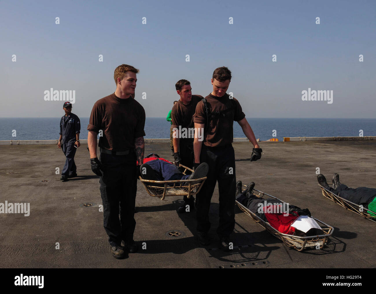 Sailors aboard USS Theodore Roosevelt (CVN 71) carry a simulated ...