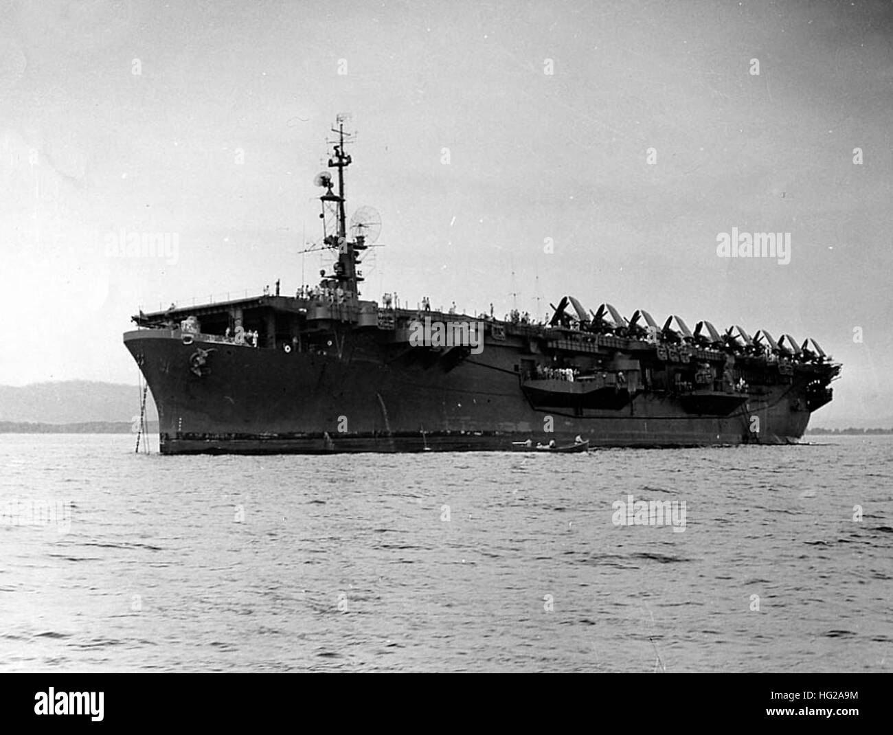 USS Palau (CVE-122) at anchor, with F4U Corsair fighters parked on her ...