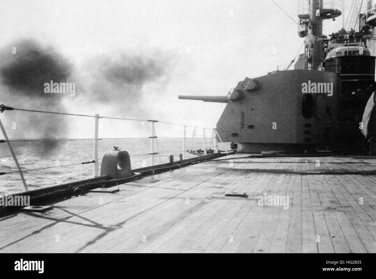 The heavy cruiser USS Newport News (CA-148) fires 127 mm artillery off ...