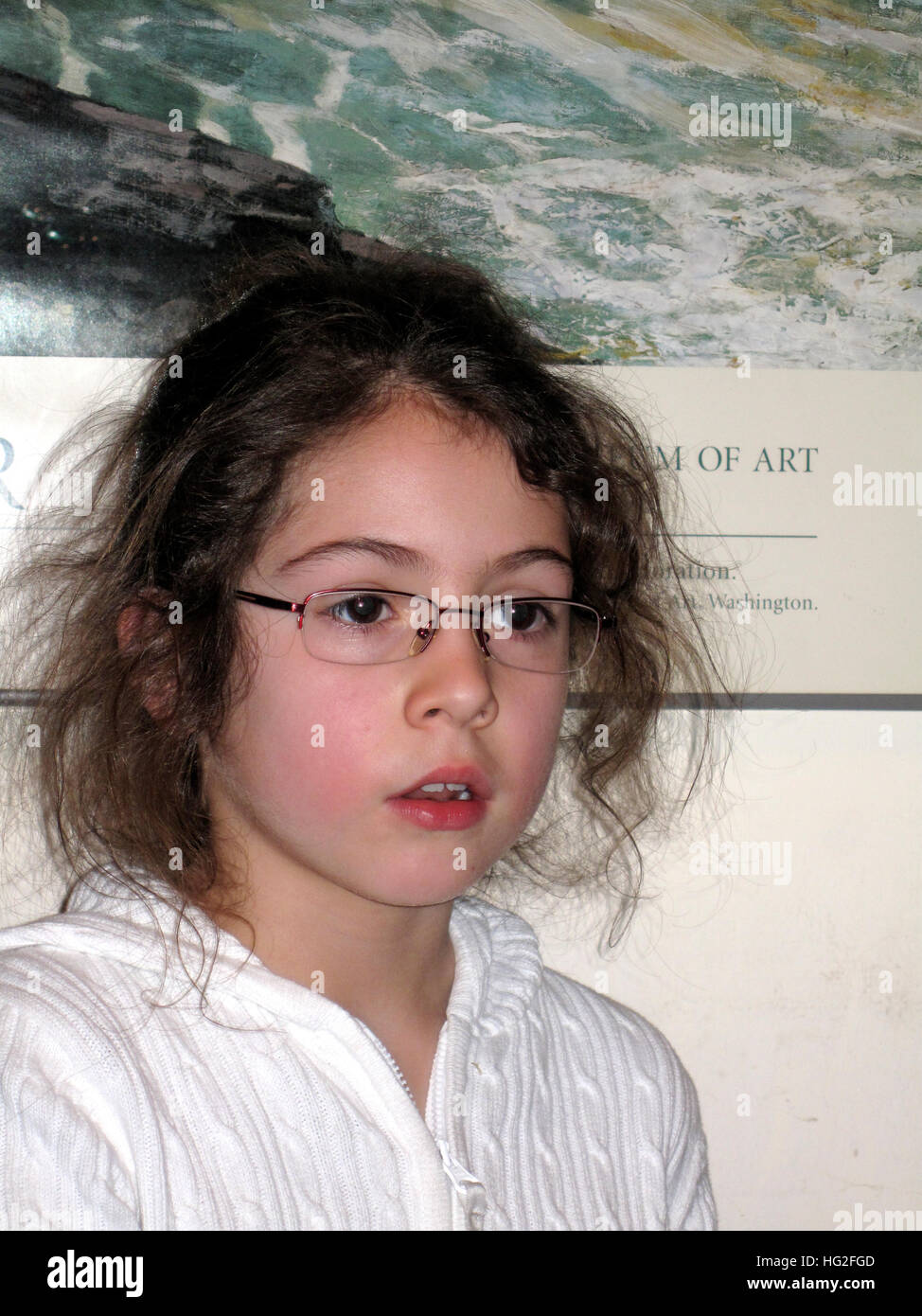Portrait of an attractive girl age 9 wearing glasses and a white ...