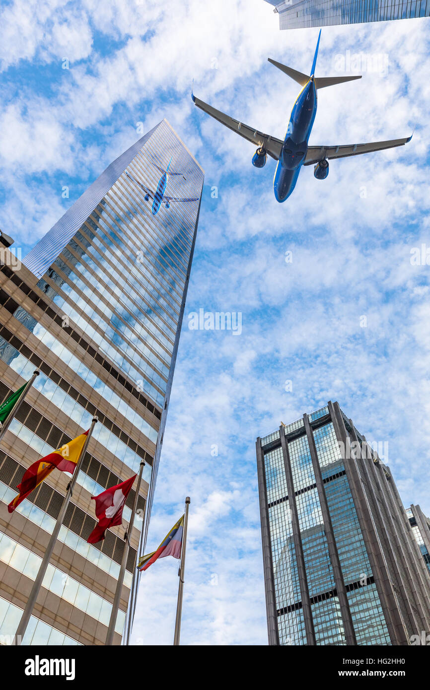 Plane flying over the city Stock Photo - Alamy