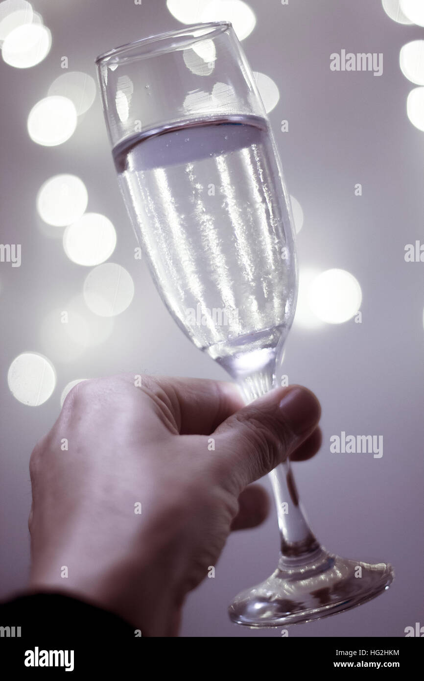 Champagne sparkling wine glass in disco party at night with defocused ...