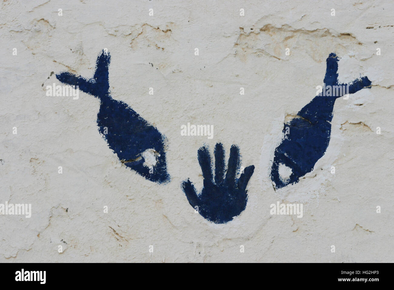 Close up picture of a hand and fish symbol on traditional berber house ...