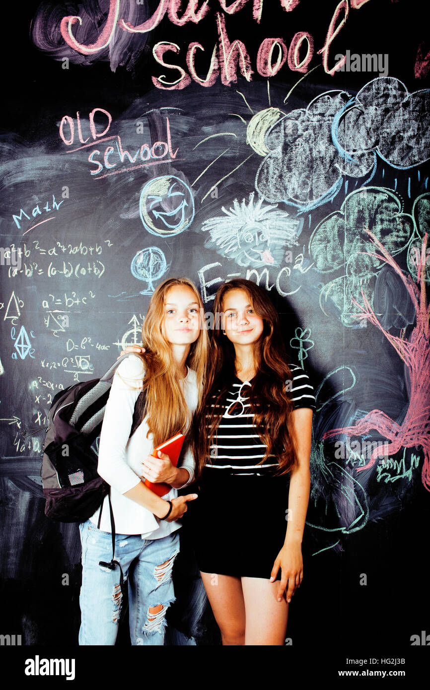 back to school after summer vacations, two teen real girls in classroom ...
