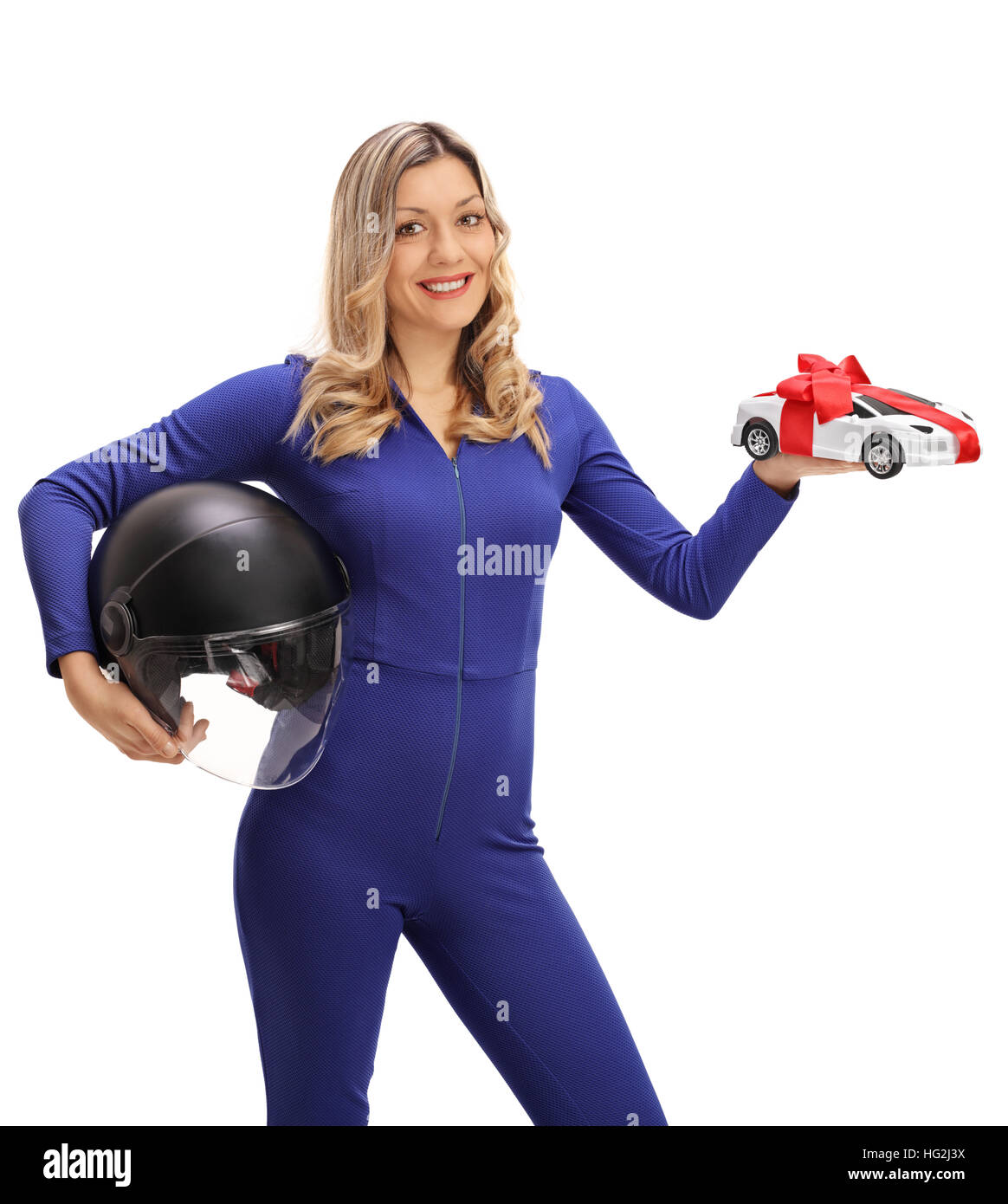 Happy female car racer holding a helmet and a model car isolated on ...