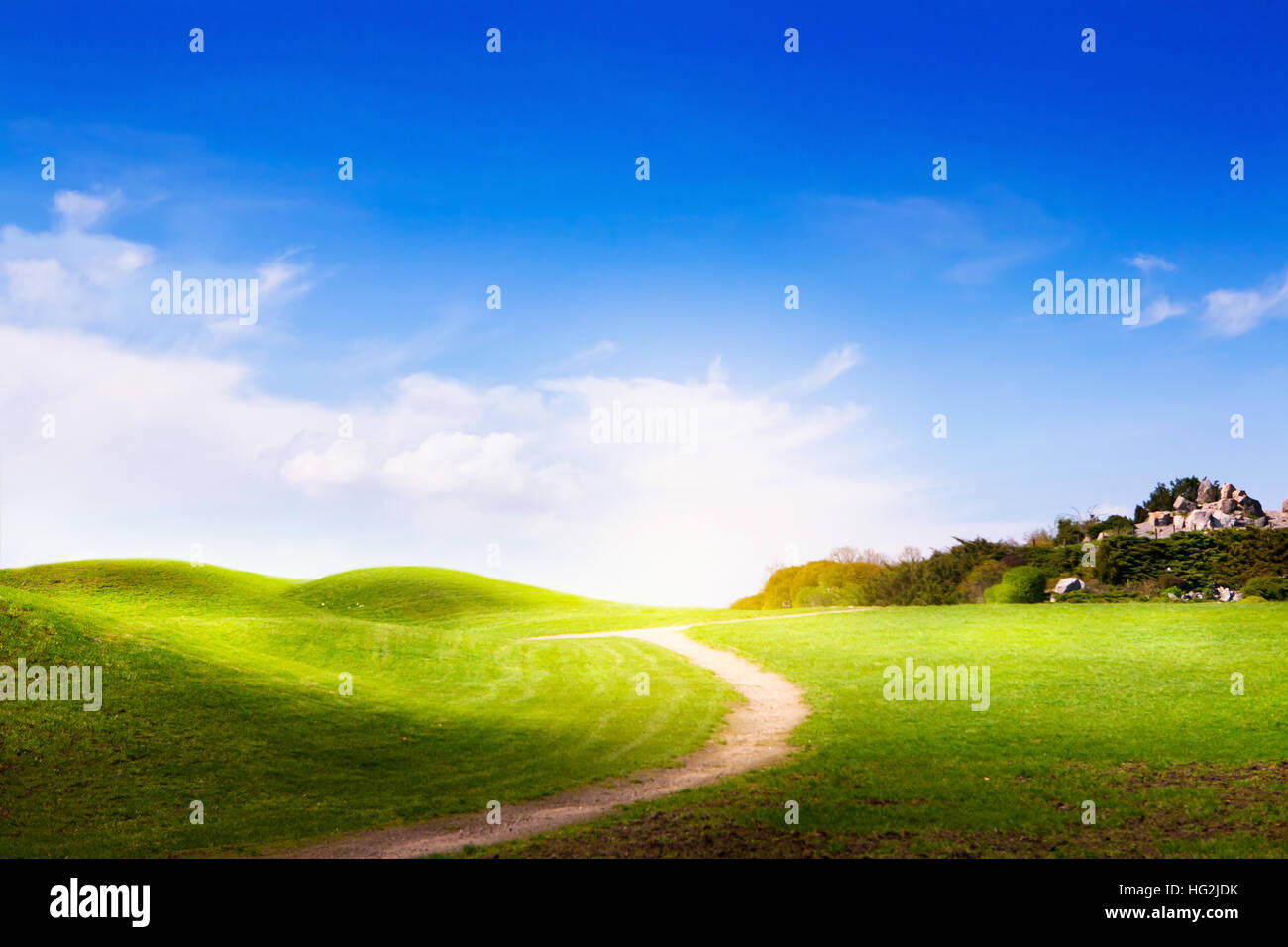 spring landscape with green grass, road and clouds Stock Photo - Alamy