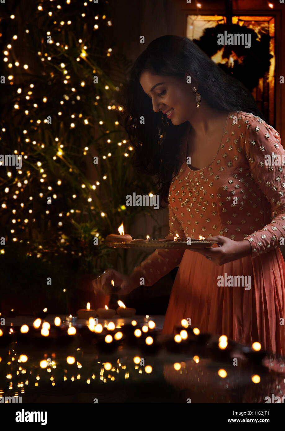 Young woman arranging oil lamps at a diwali festival Stock Photo - Alamy