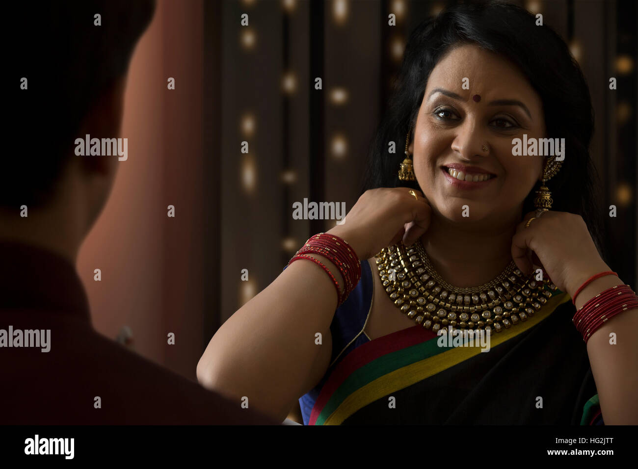 Happy mother trying on necklace Stock Photo - Alamy