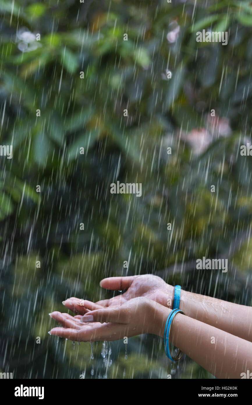 Woman hand with bangles enjoying rain in outdoor Stock Photo - Alamy