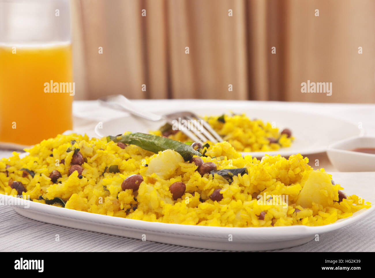 Indian breakfast poha and juice Stock Photo - Alamy