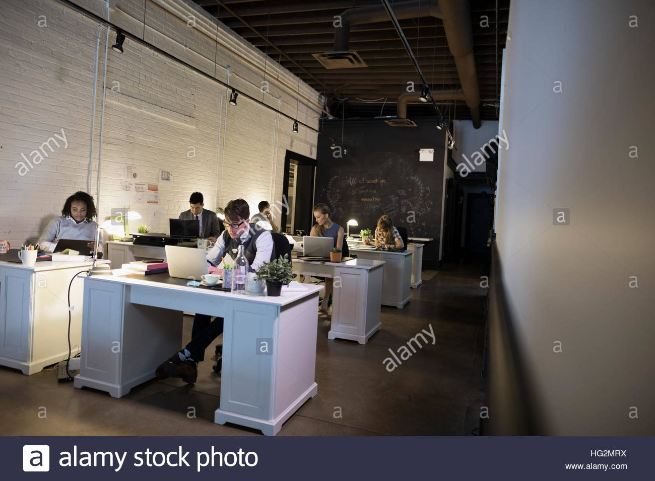 Creative business people working at desks in open plan office Stock ...