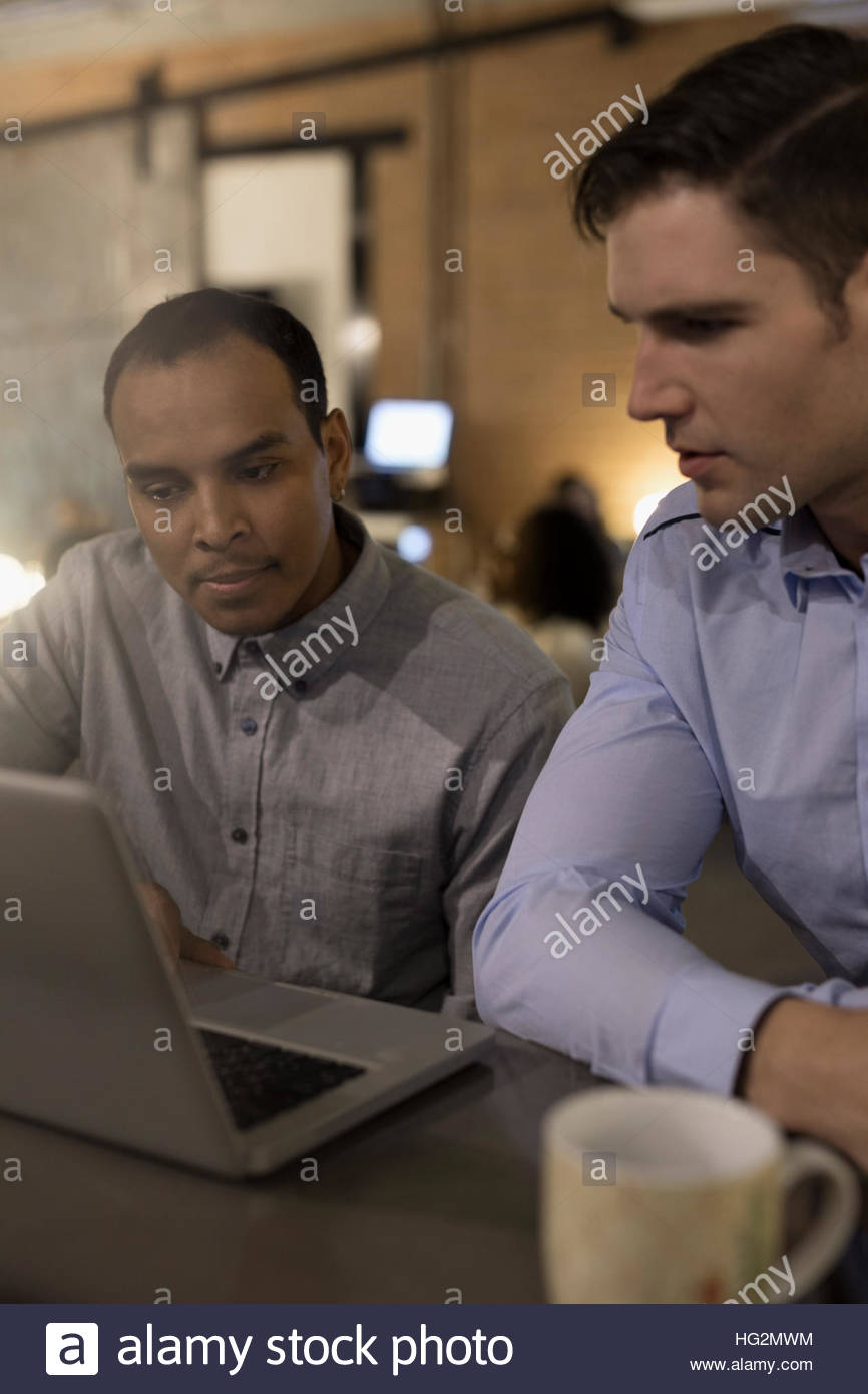 Serious businessmen working at laptop Stock Photo - Alamy