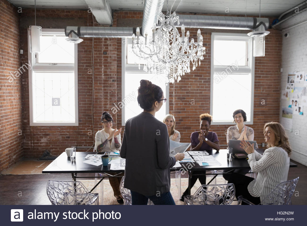 Female designers meeting and clapping in conference room Stock Photo ...