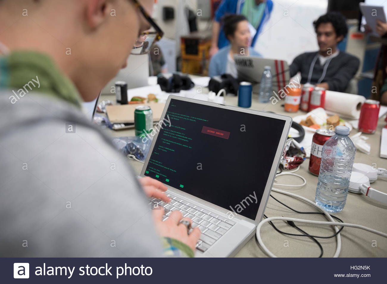 Hacker coding working hackathon at laptop Stock Photo - Alamy
