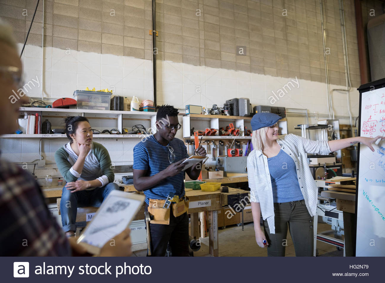 Design professional engineers brainstorming at flip chart in workshop ...